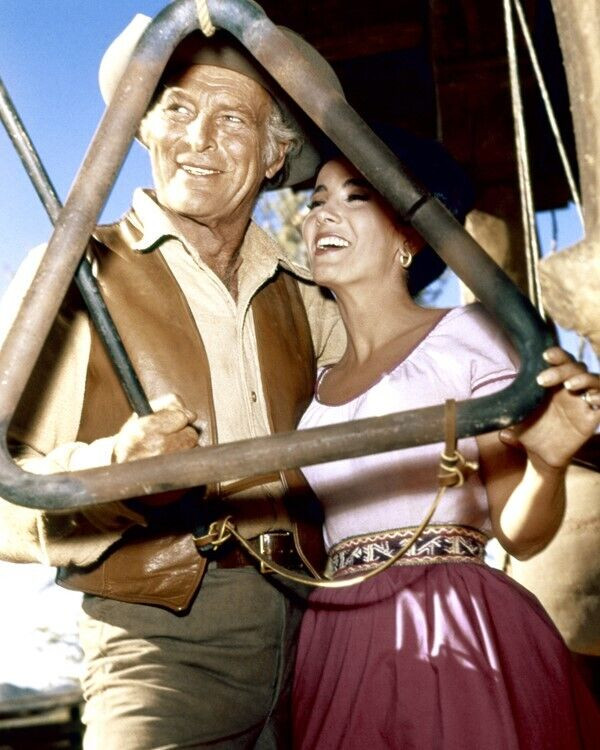 The High Chaparral Leif Erickson & Linda Cristal pose by ranch bell 8x10 photo - Moviemarket